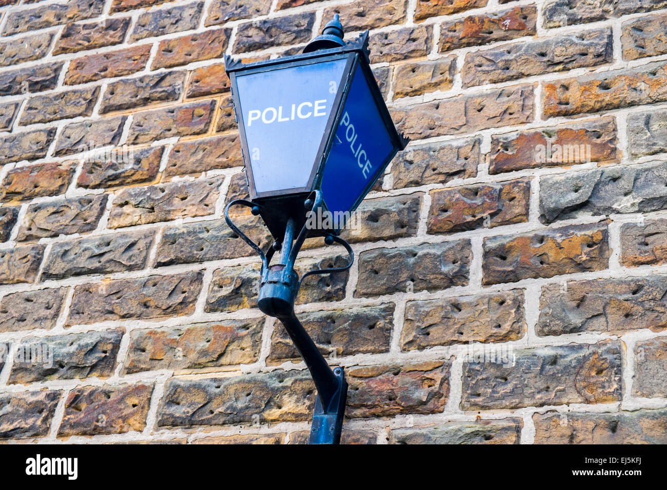 traditional english police blue lamp outside a police station in ...