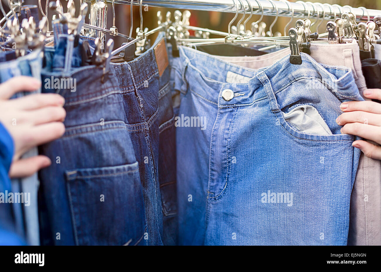 Hands on clothing rack hi-res stock photography and images - Alamy