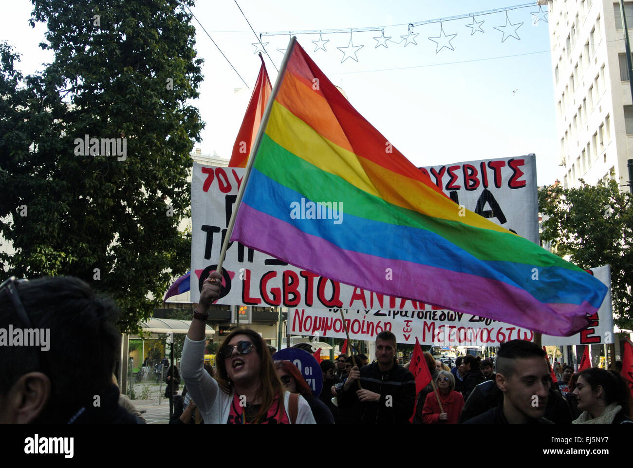 A demonstrator waves a rainbow flag symbol of the LGBT community. Left ...