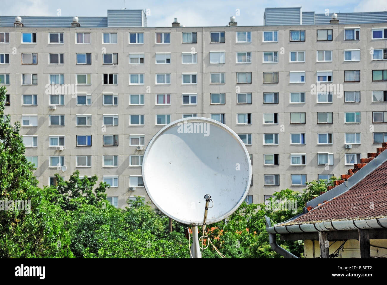 Satellite dish in front of a high apartment building Stock Photo - Alamy