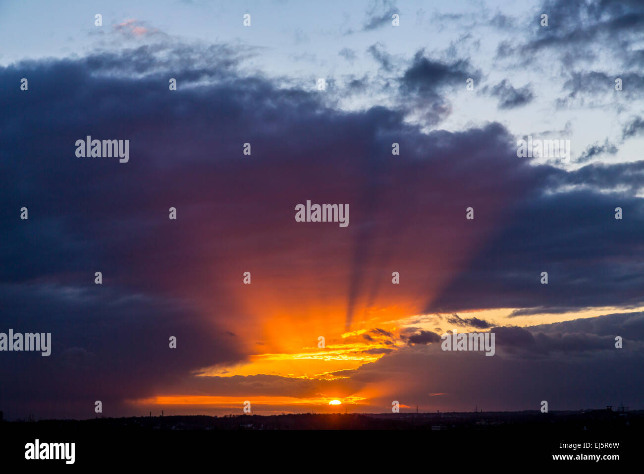 Dramatic sunset, dark clouds Stock Photo - Alamy