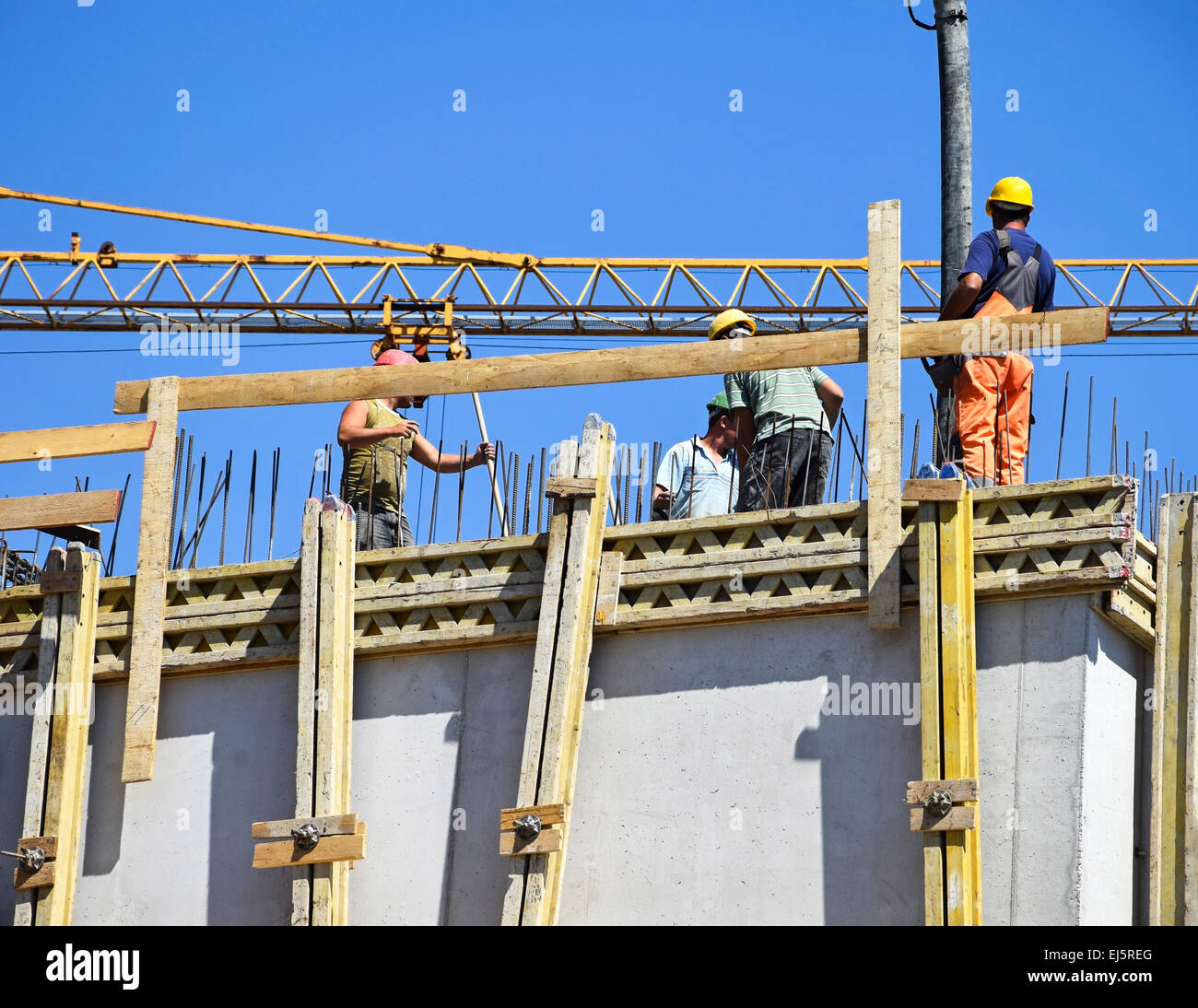 Construction workers are working at the construction of a new building ...