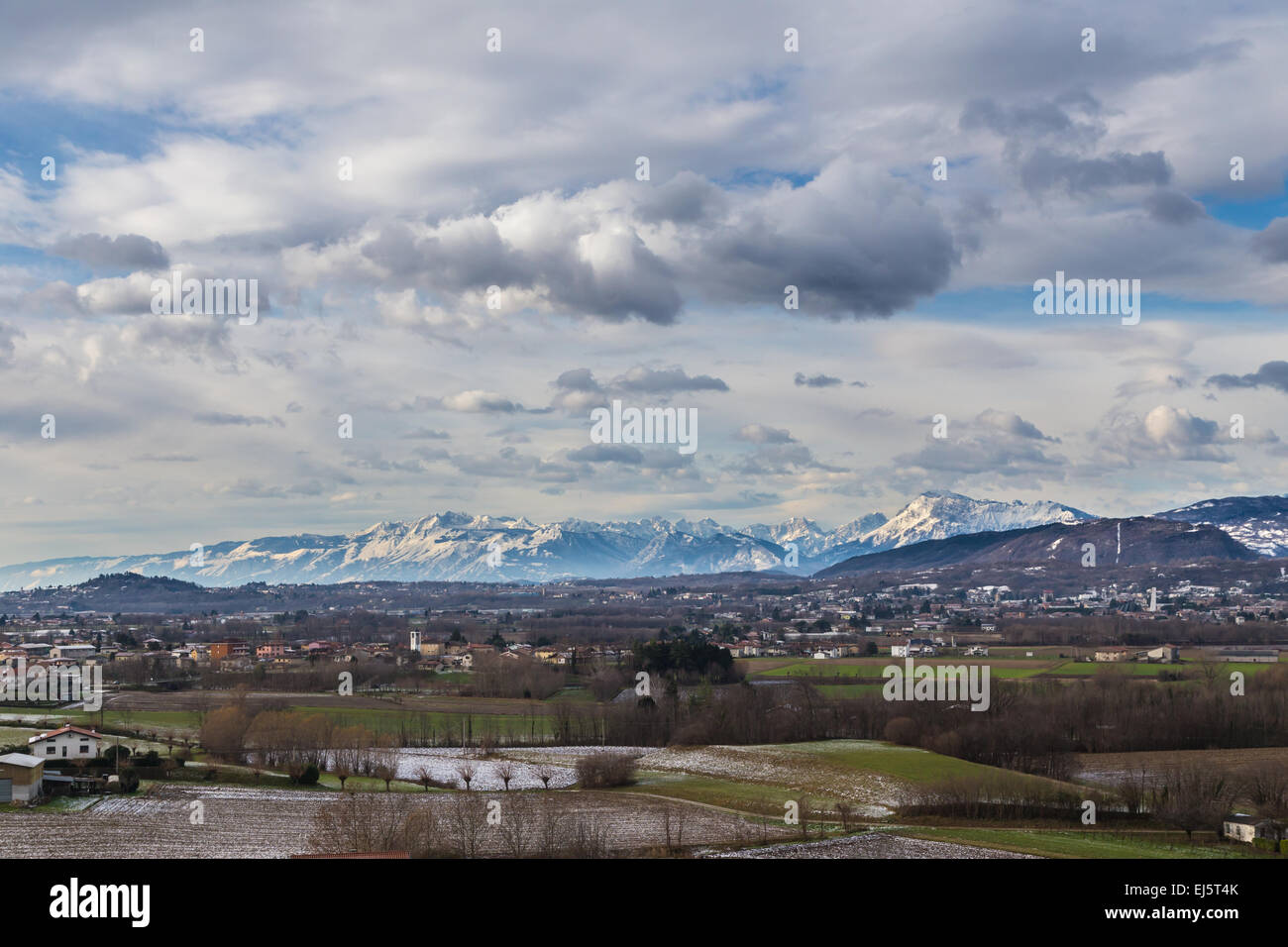 a light snowfall on the italian countryside, with white fields and ...