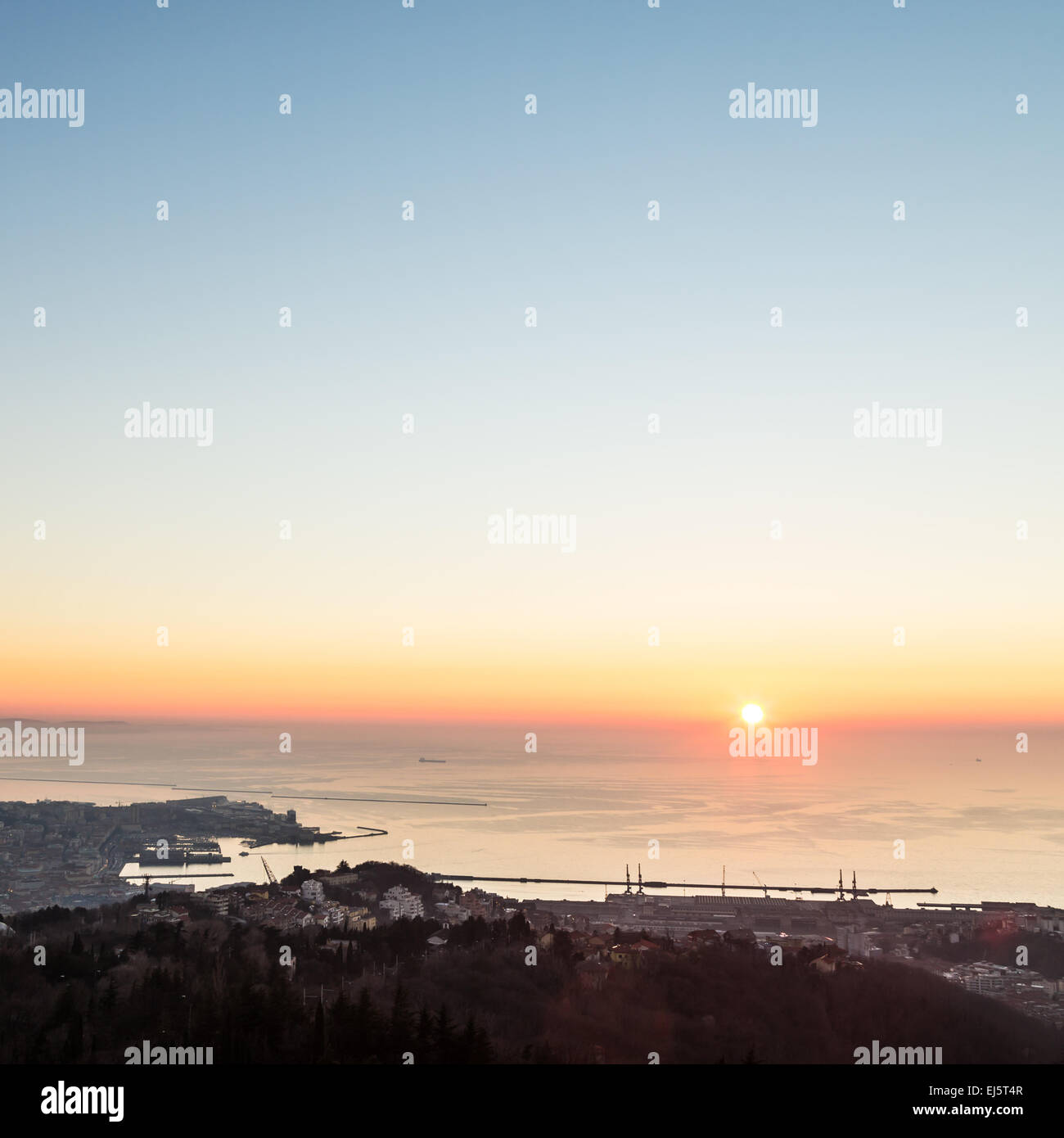the sun goes down in the bay of Trieste, Italy Stock Photo - Alamy