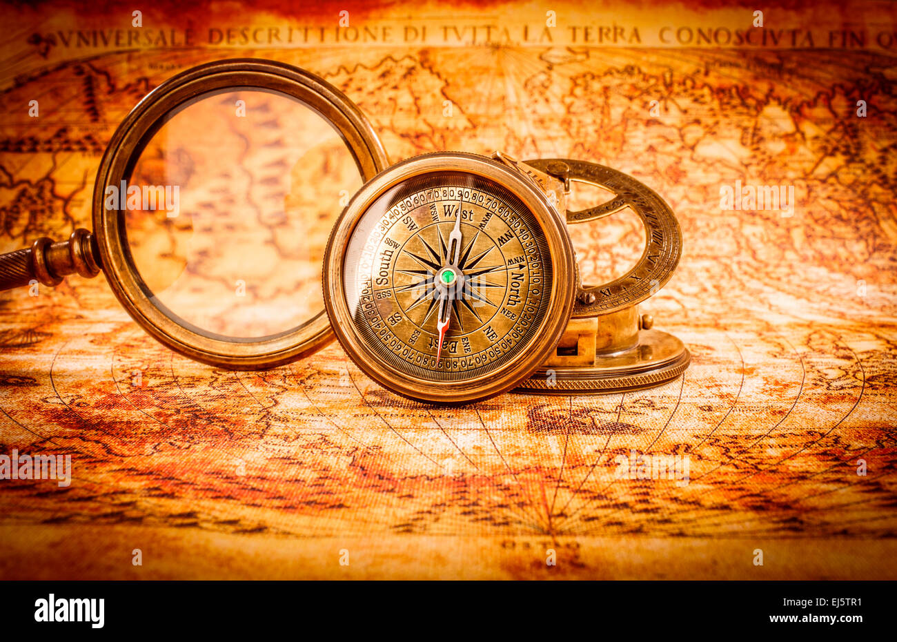 Vintage still life. Vintage magnifying glass and compass lies on an ...