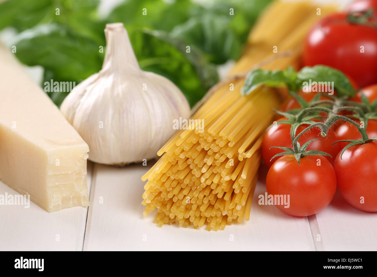 Ingredients for a spaghetti pasta noodles meal with tomatoes, basil and ...