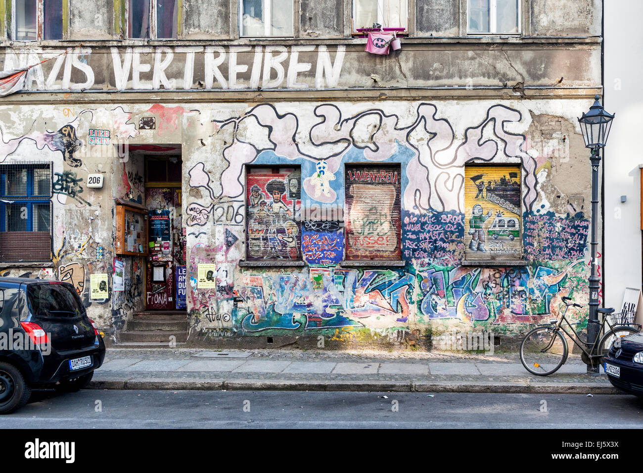 Dilapidated exterior, window and graffiti on old squatters' building in ...