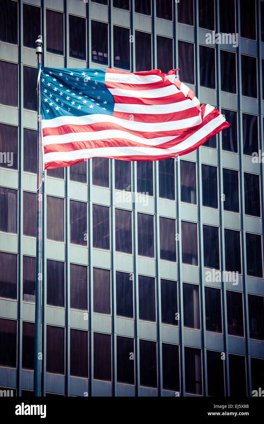US american symbol flag over blue modern city buildings Stock Photo - Alamy