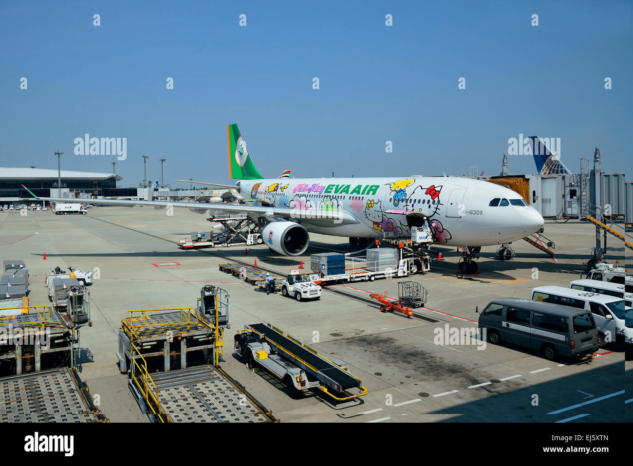 TOKYO, JAPAN - MAY 15: Airplane loading cargo at Narita airport on May ...