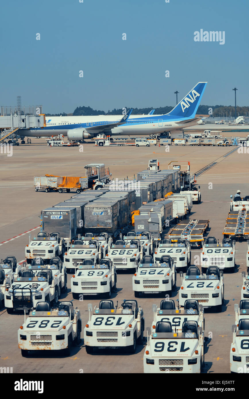TOKYO, JAPAN - MAY 15: Airplane loading cargo at Narita airport on May ...