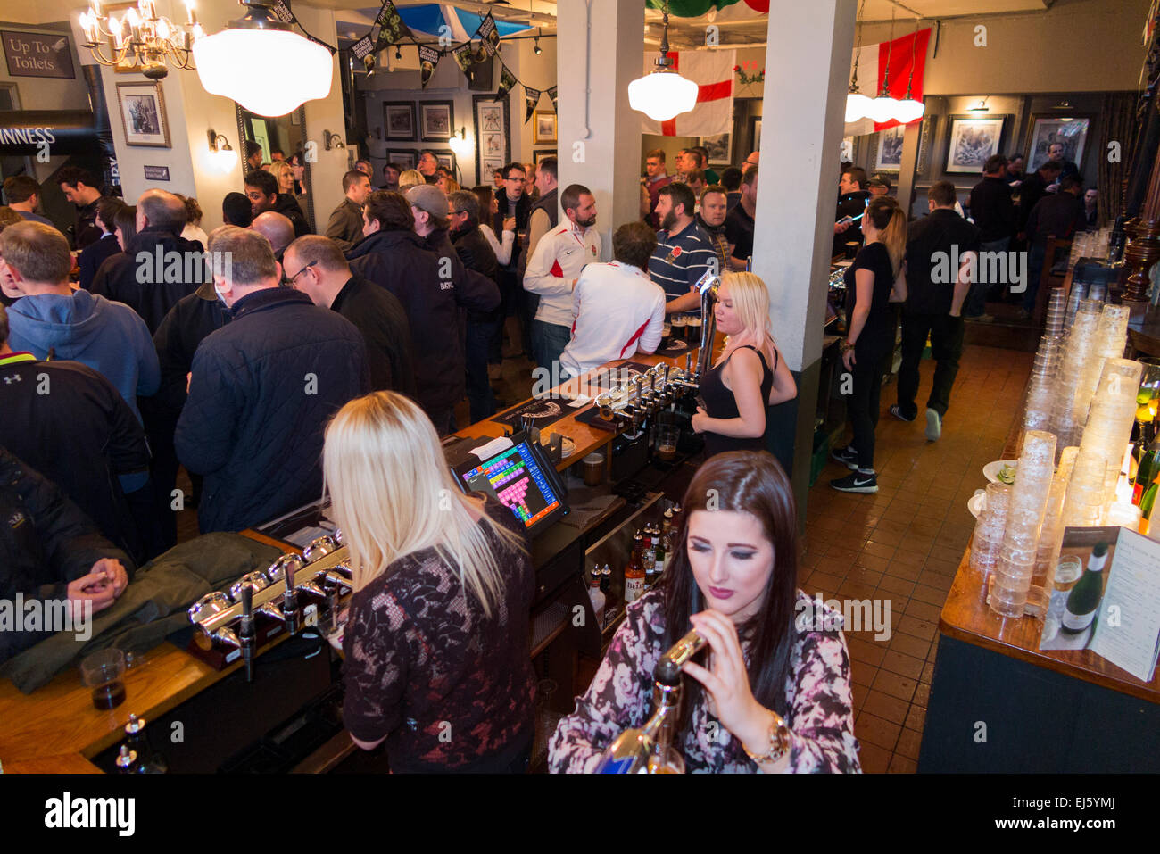 Bar and barmaid / staff / barman man & rugby fan fans at busy The Bear ...