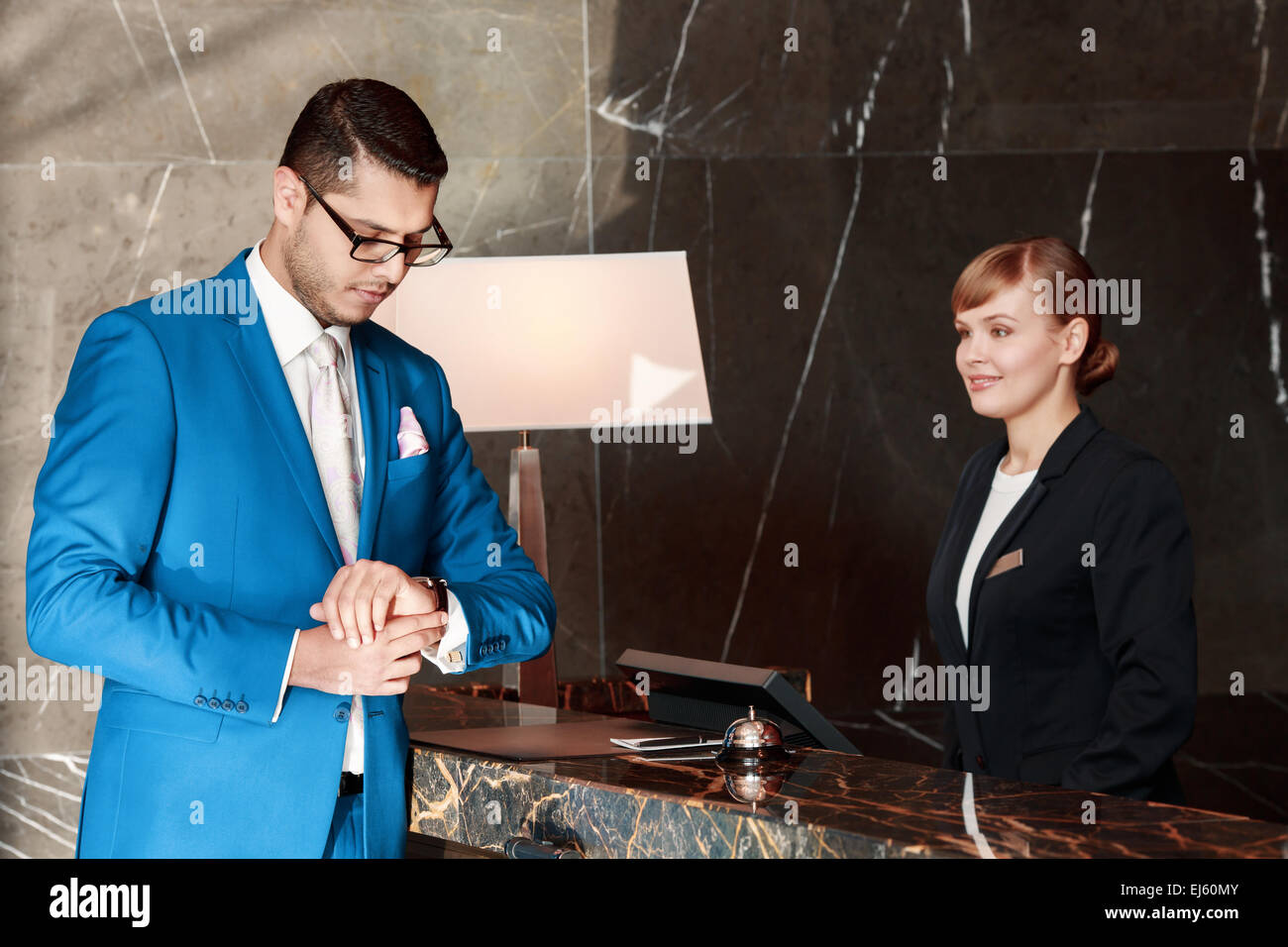 Guest communicating with a receptionist Stock Photo - Alamy