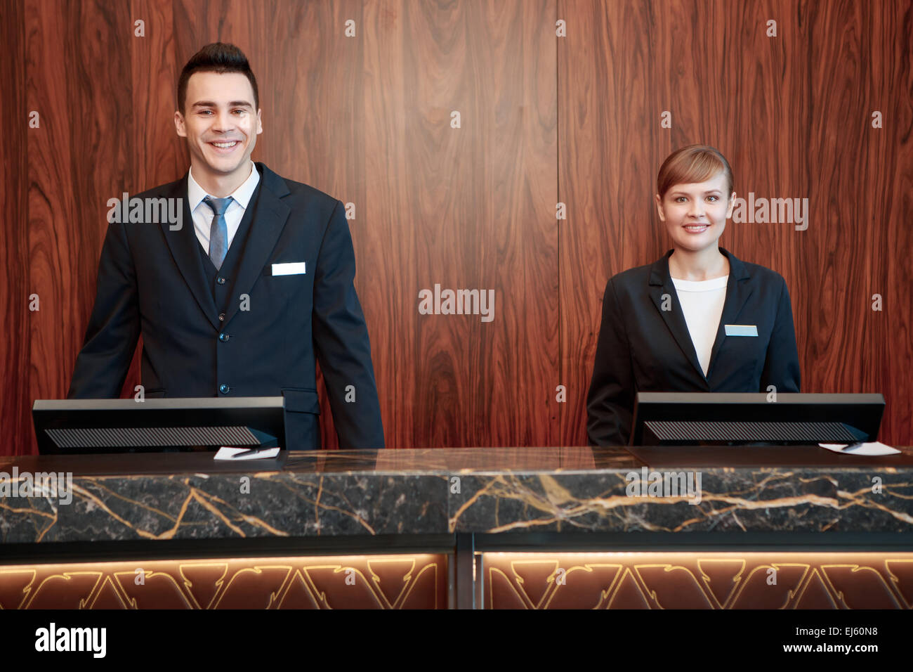 Hotel receptionist behind desk hi-res stock photography and images - Alamy