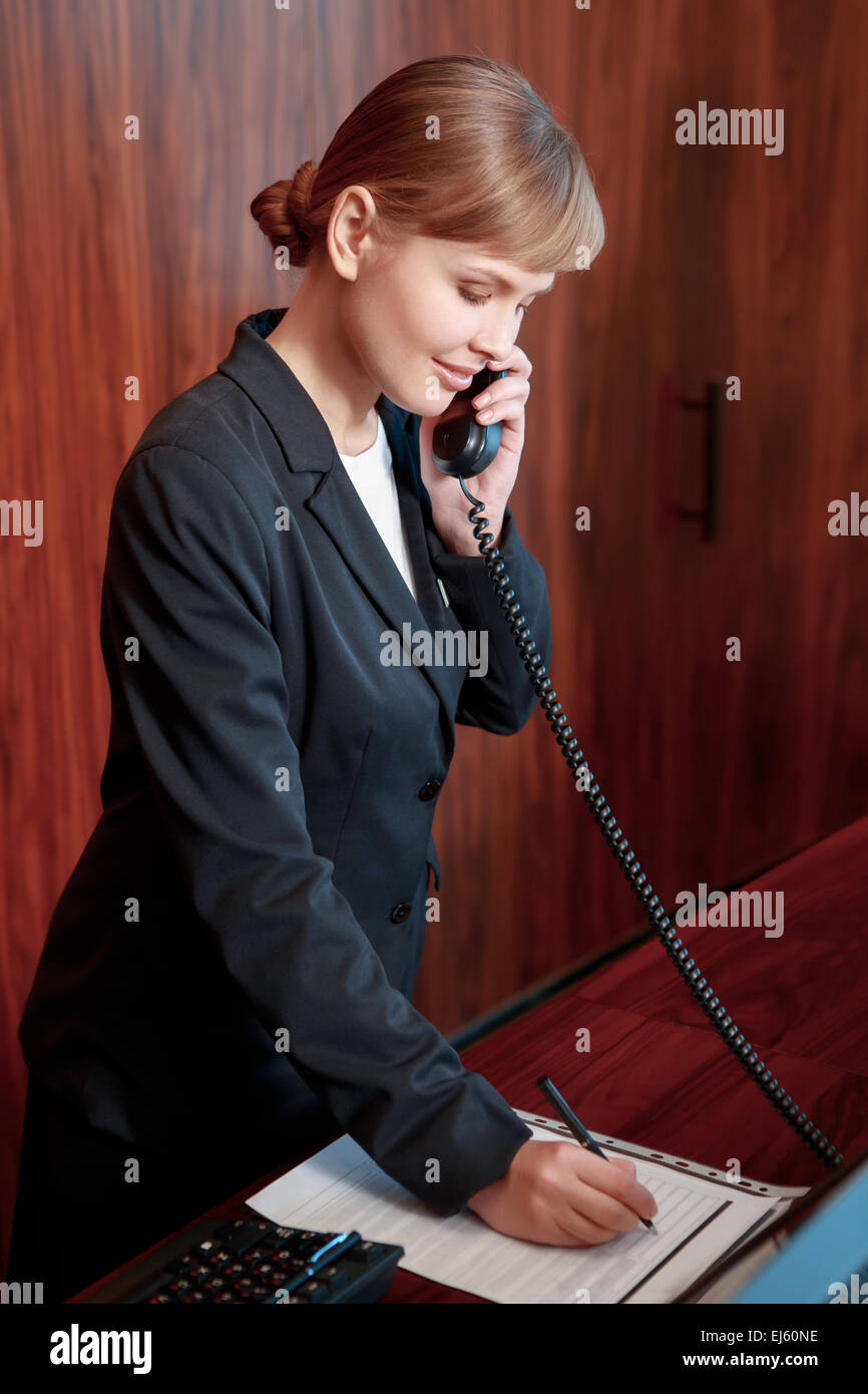 Receptionist answering the call Stock Photo - Alamy