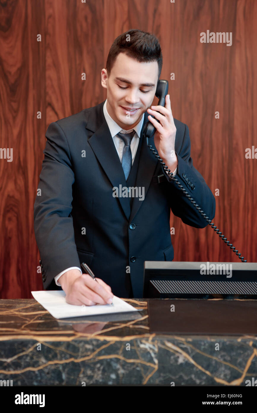 Receptionist answering the call Stock Photo - Alamy