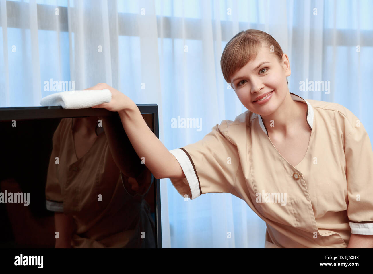 Hotel maid dusting furniture Stock Photo - Alamy