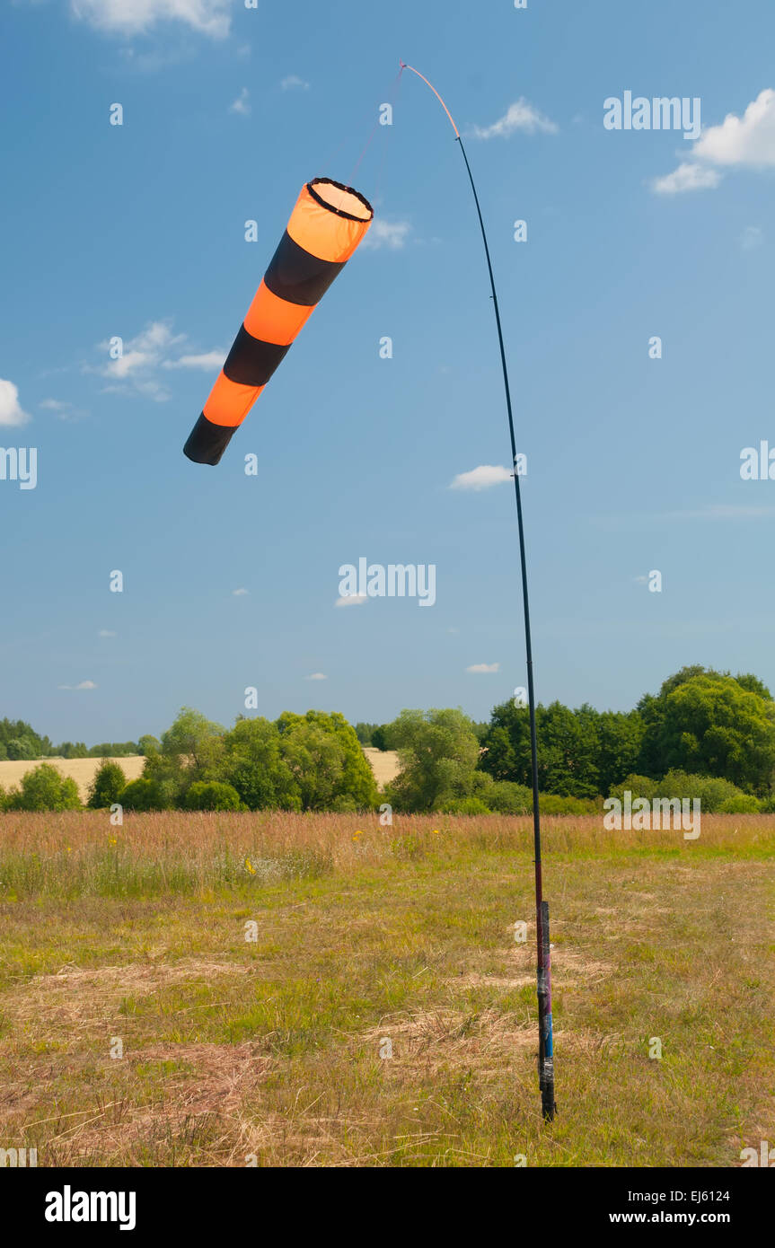 Striped windsock shows direction of the wind Stock Photo - Alamy