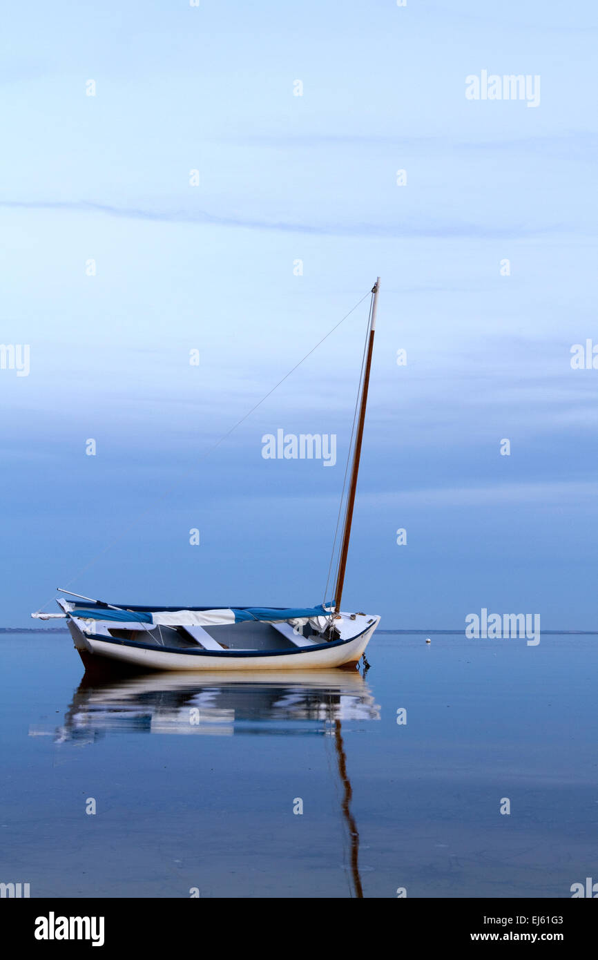 Cape Cod Sailboat with reflections on beautiful beach at low tide ...