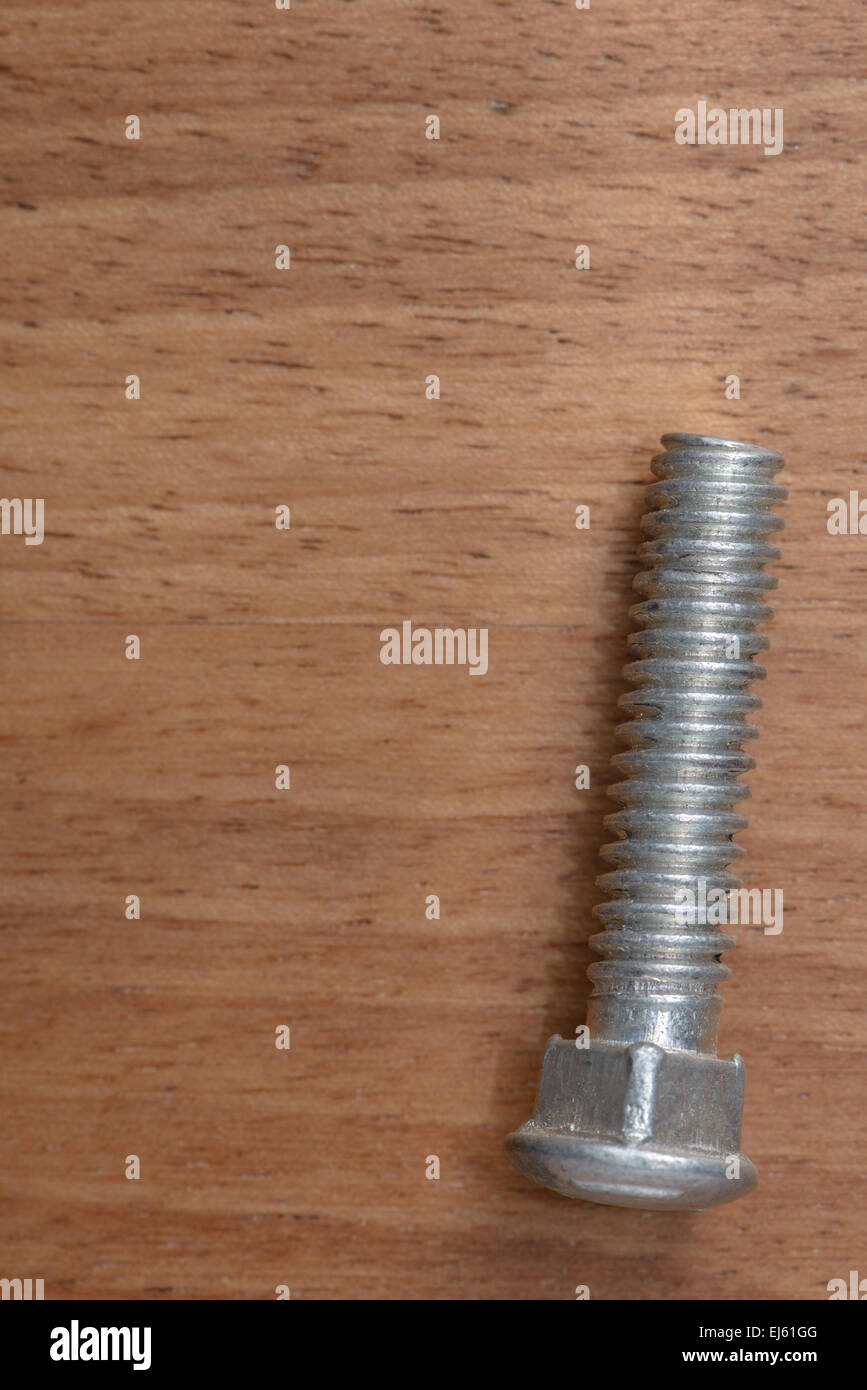 One bolt on wood blur background Stock Photo - Alamy