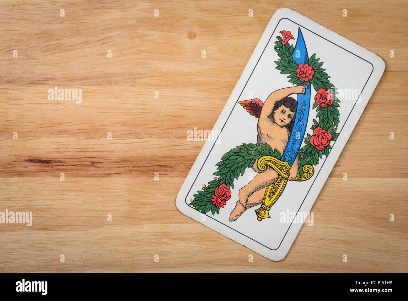 Sword ace italian card on a wood background Stock Photo - Alamy