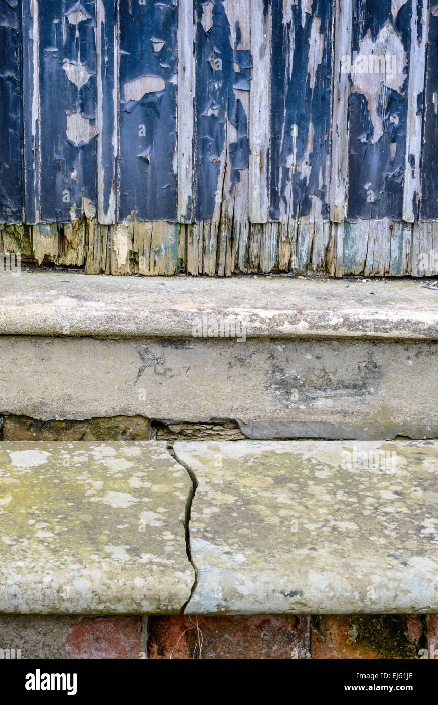 An old door with interesting peeling paint texture, and old steps. In ...
