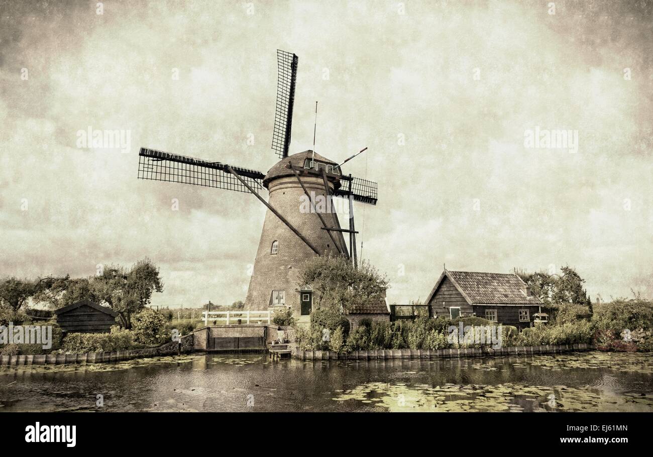 Ancient windmill in Kinderdijk, Holland. Stylization under an old card ...
