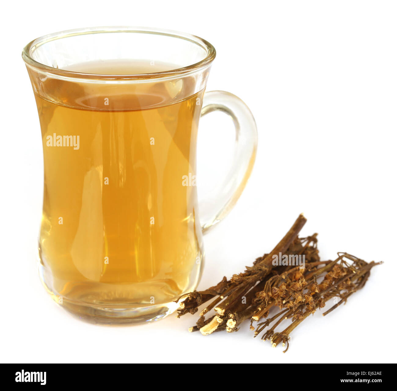 Ayurvedic medicinal Chirata with juice in glass over white background ...