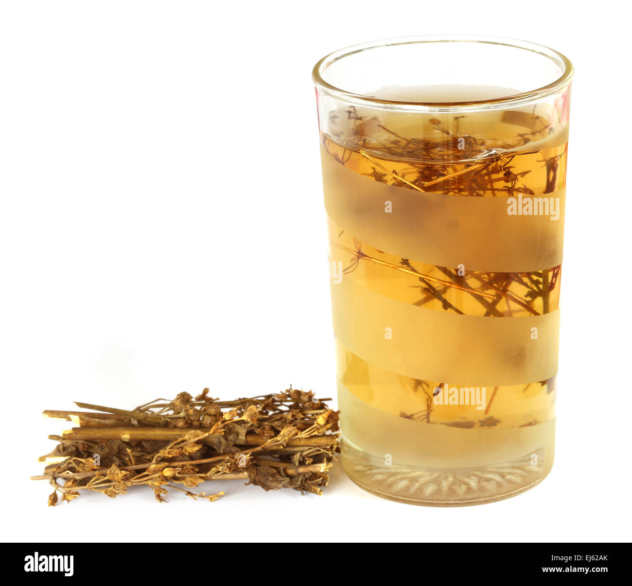 Ayurvedic medicinal Chirata with juice in glass over white background ...