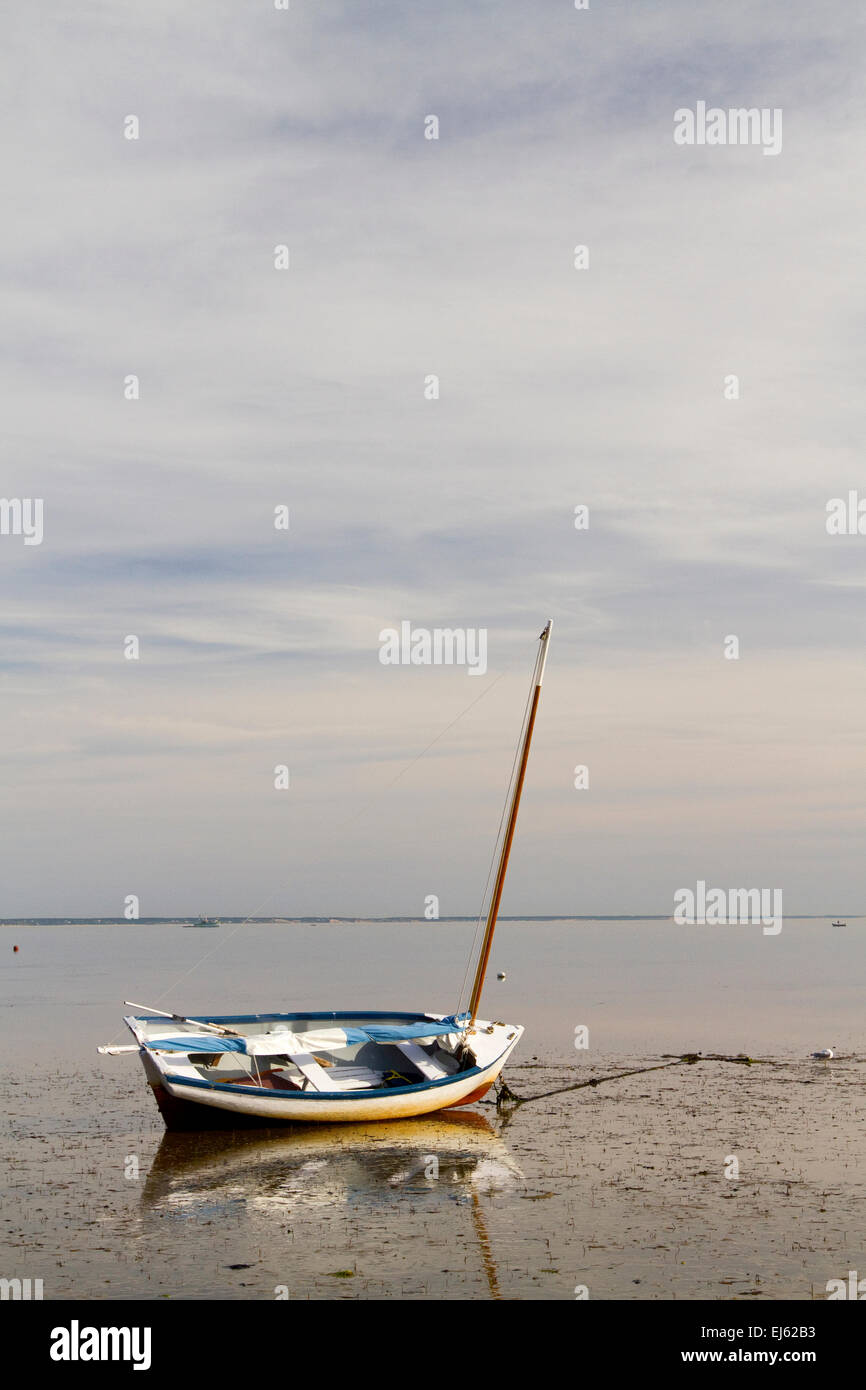 Sailboat with reflections on beautiful beach at low tide. Provincetown ...