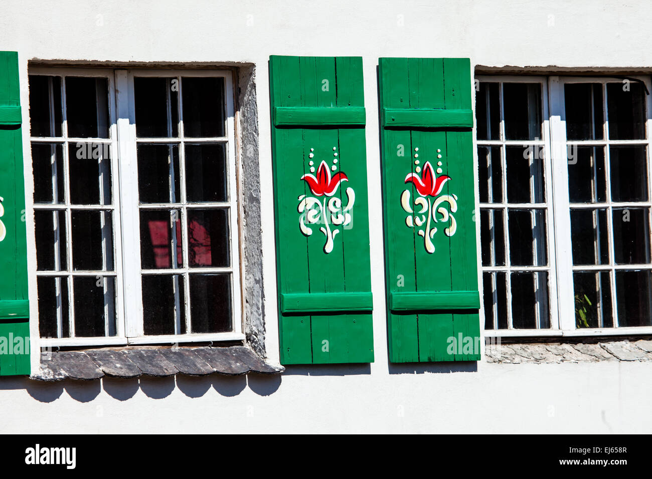 Typical germany windows with green shutters and window box Stock Photo ...