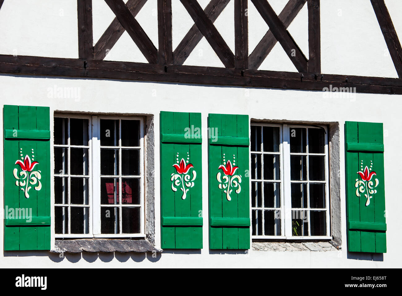 Typical germany windows with green shutters and window box Stock Photo ...
