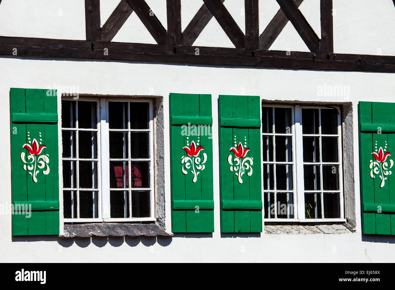 Typical germany windows with green shutters and window box Stock Photo ...
