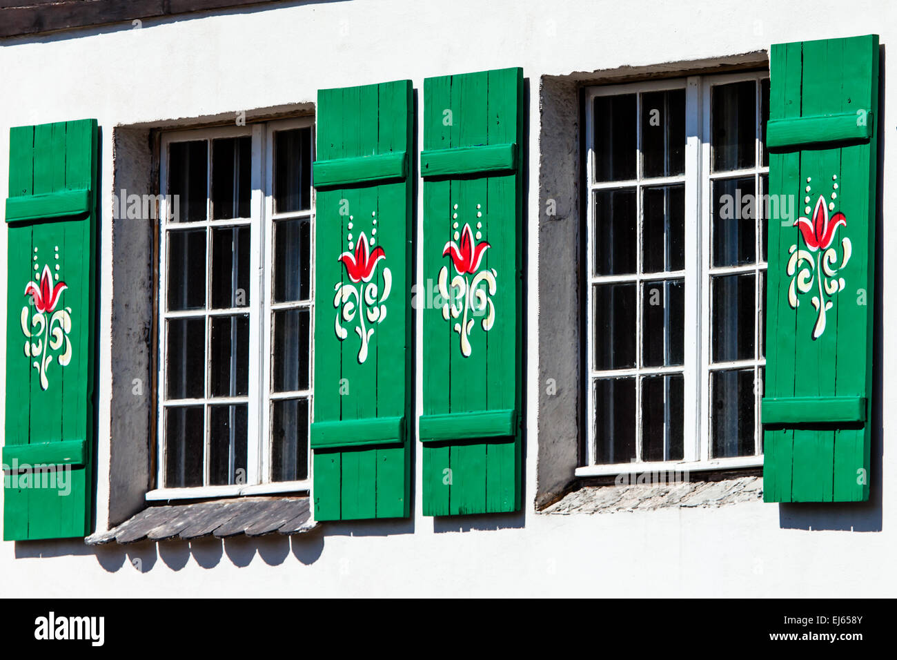 Typical germany windows with green shutters and window box Stock Photo ...