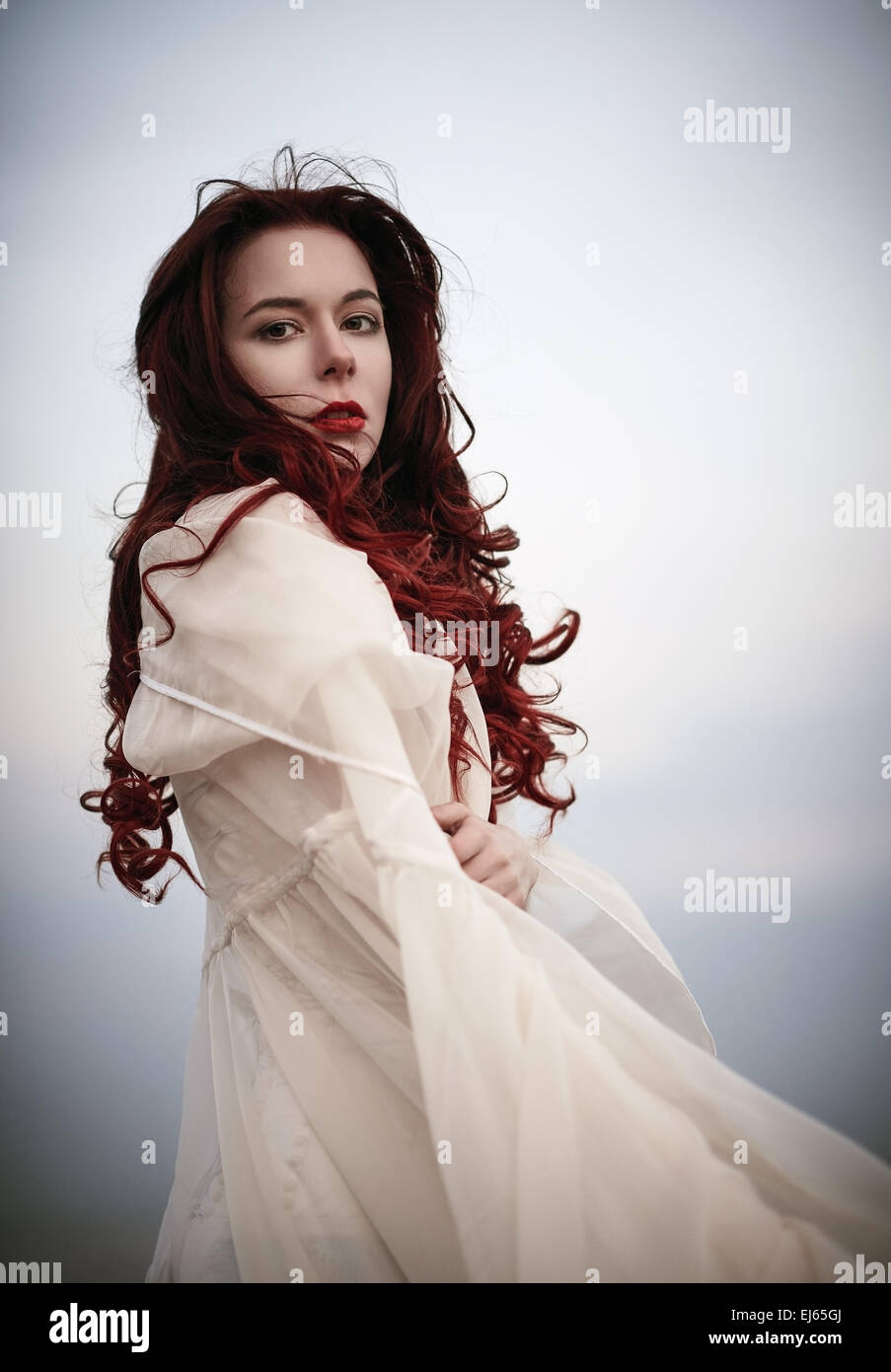 Portrait of a beautiful sad young woman in white dress Stock Photo - Alamy