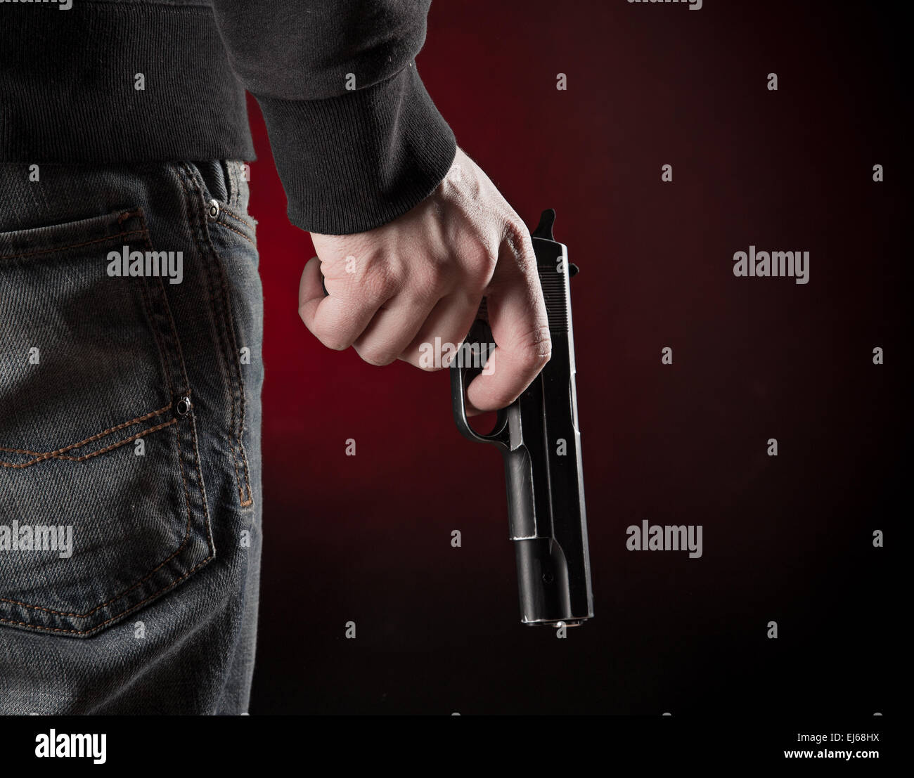 Killer with gun close-up on dark background Stock Photo - Alamy
