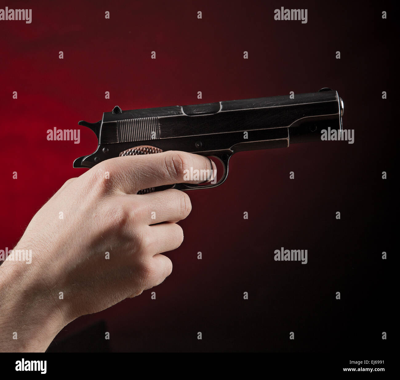 Killer with gun close-up on dark background Stock Photo - Alamy