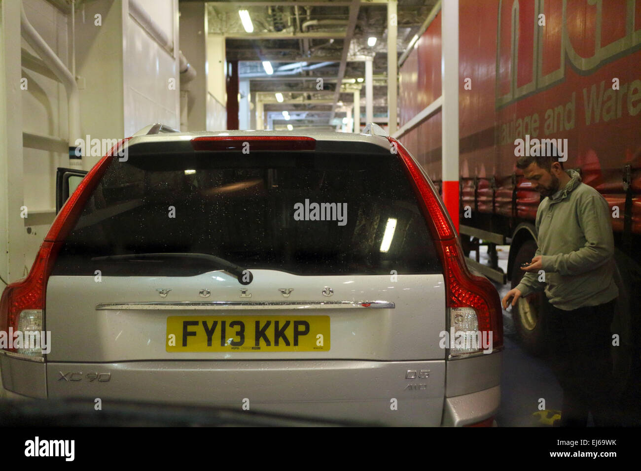 man locking car on ferry deck in the uk Stock Photo - Alamy