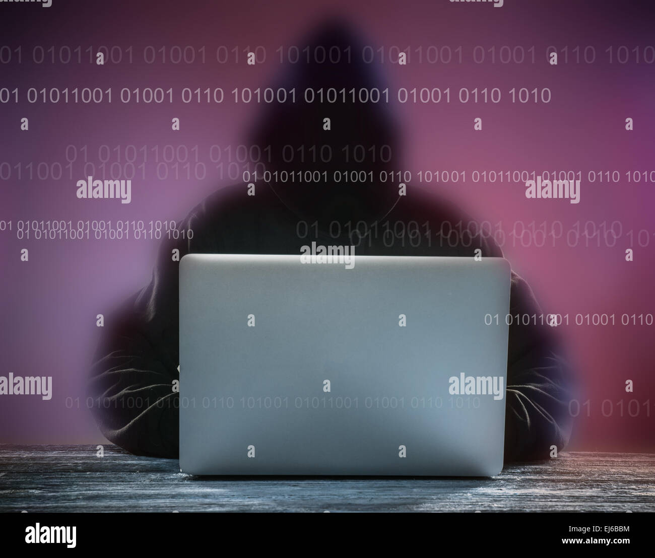 A hacker with a hood with laptop. Online network danger Stock Photo - Alamy