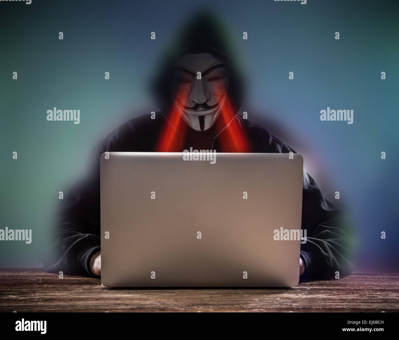 A hacker with a hood with laptop. Online network danger Stock Photo - Alamy