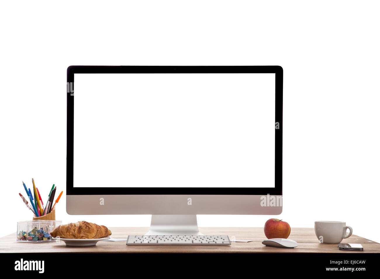 Computer display on wooden table Stock Photo - Alamy