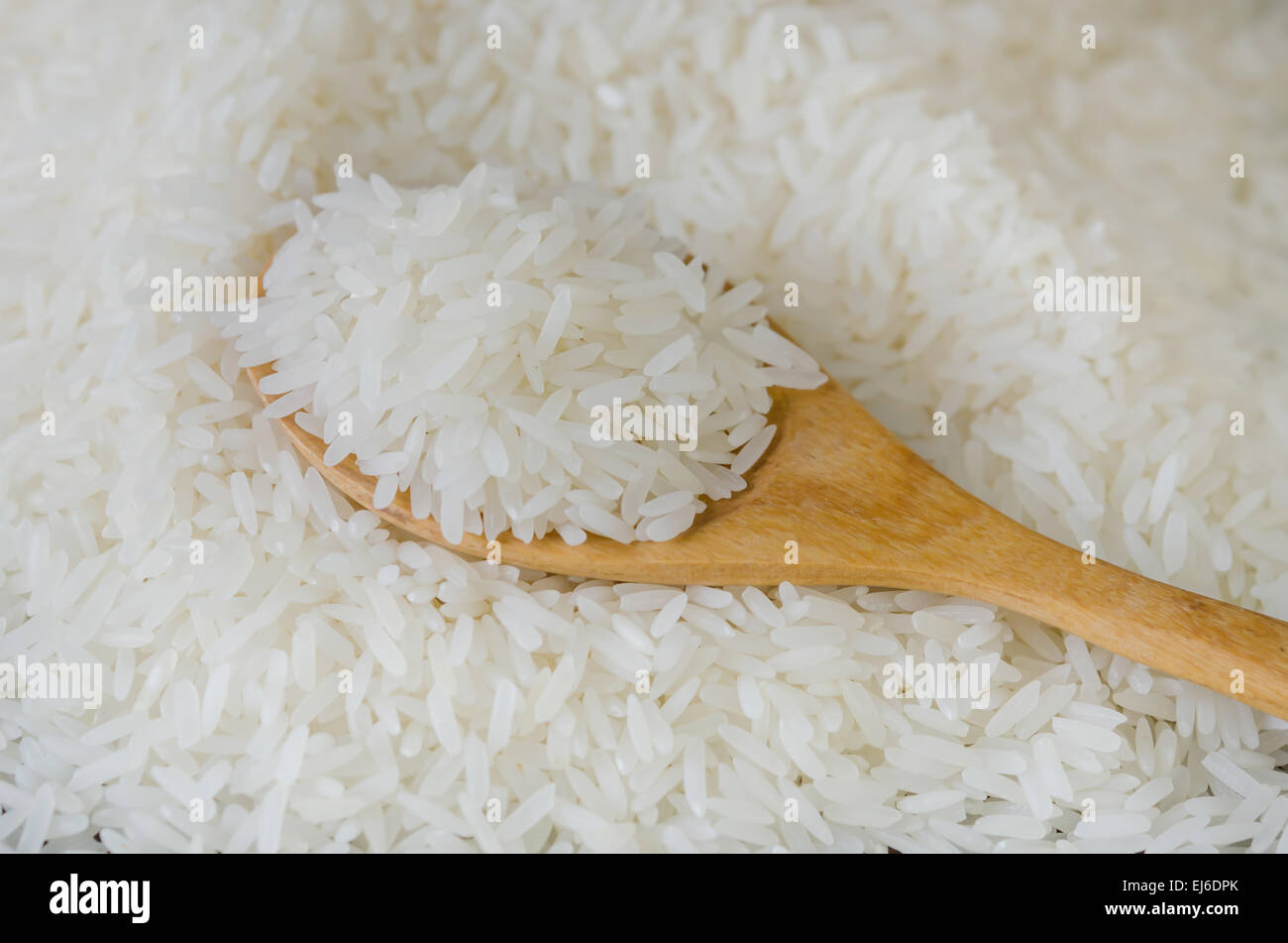 Wooden spoon with rice lying against the background rice Stock Photo ...