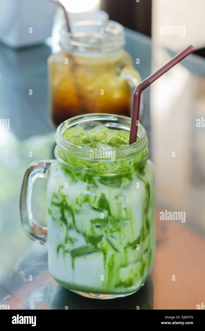 close up iced milk green tea with drinking straw on table Stock Photo ...