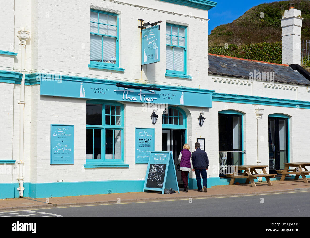 Couple walking into the Pier Bar & Restaurant, Ilfracombe, Devon ...