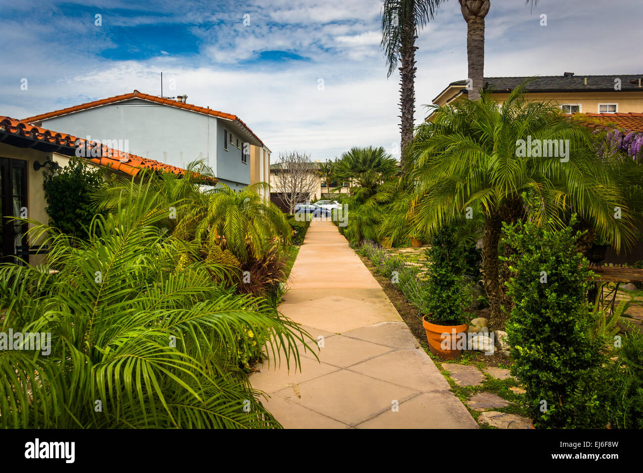 Gardens and houses along walkway, on Lido Isle, in Newport Beach ...