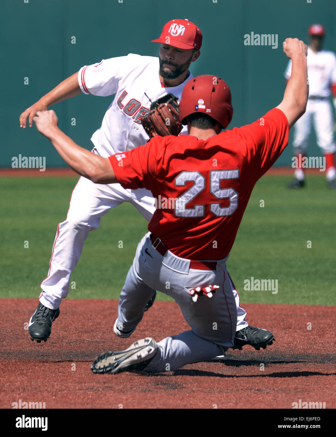 Usa. 22nd Mar, 2015. SPORTS -- The Lobos Jared Holley, left, tags out Houston's Chris Iriart, 24 ...