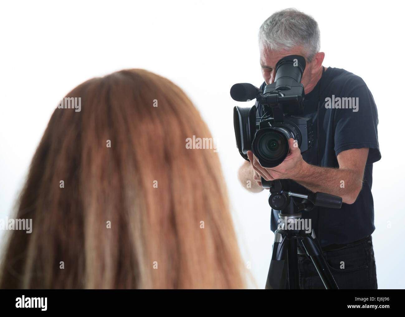 A camera man shooting a video for his company Stock Photo - Alamy