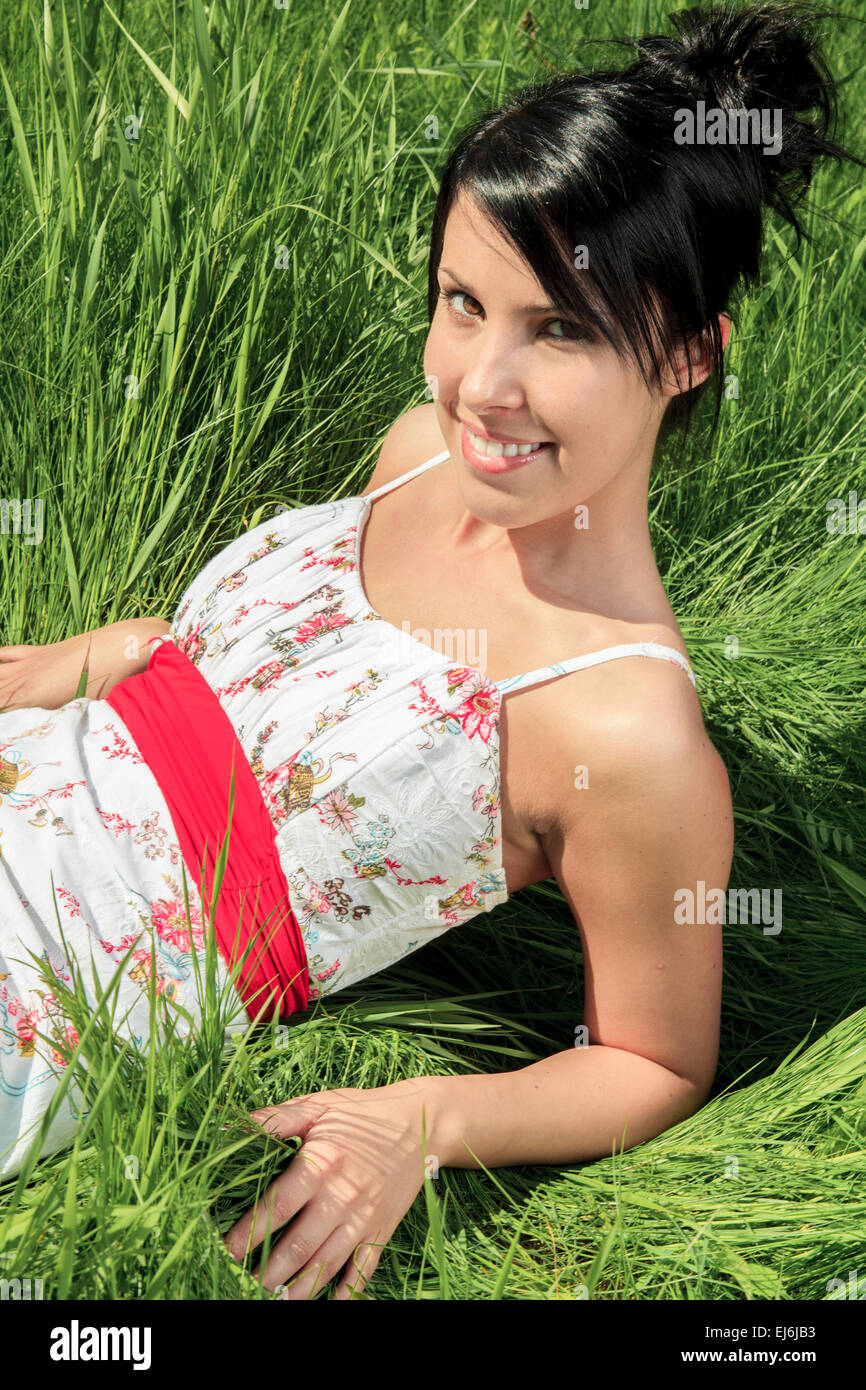 Young model laying in the grass Stock Photo - Alamy