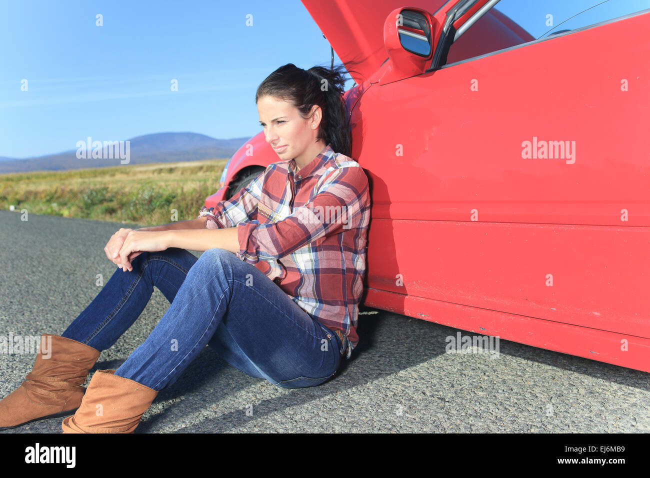 A woman having a car problem on the side of the road Stock Photo - Alamy