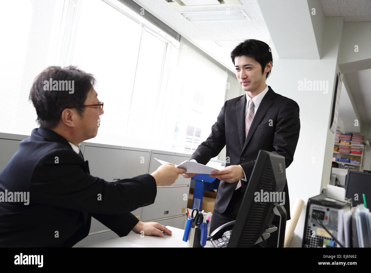 Young Japanese businessman working with his boss Stock Photo - Alamy