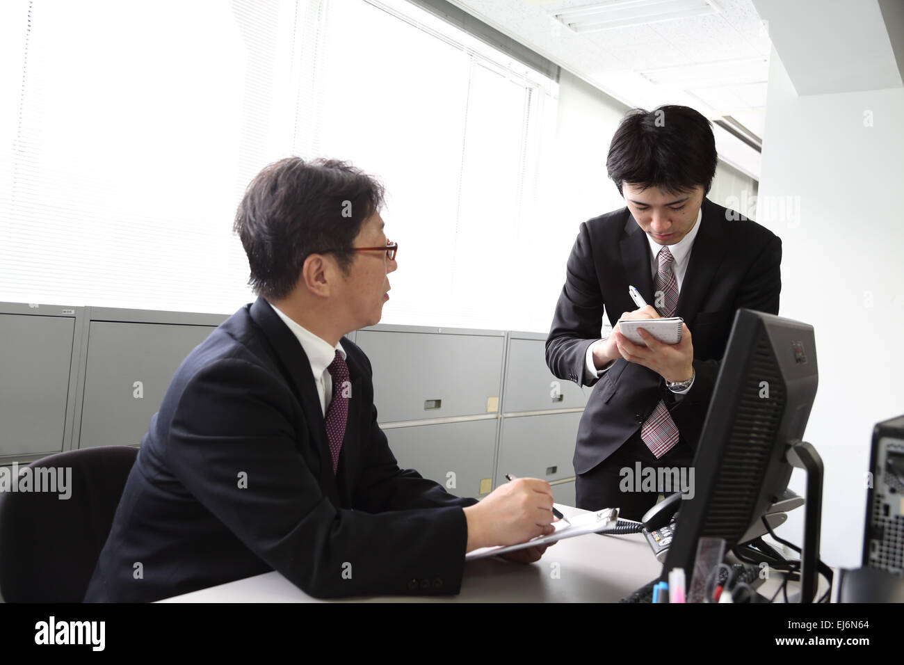 Young Japanese businessman working with his boss Stock Photo - Alamy